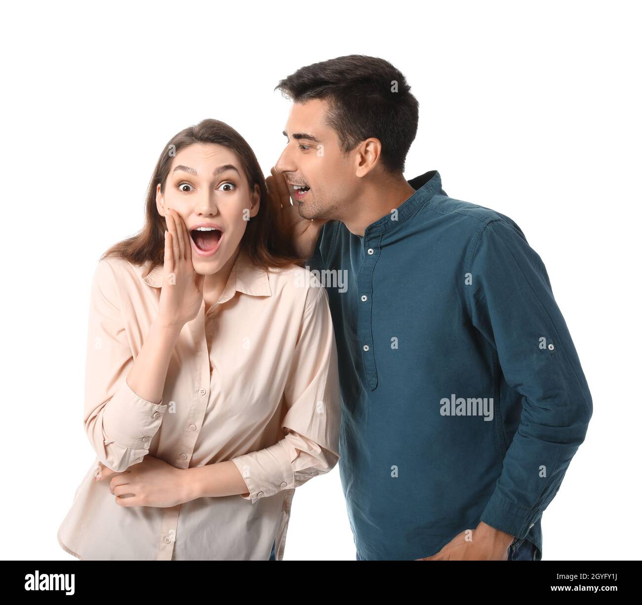 Young man sharing gossip with his girlfriend on white background Stock ...