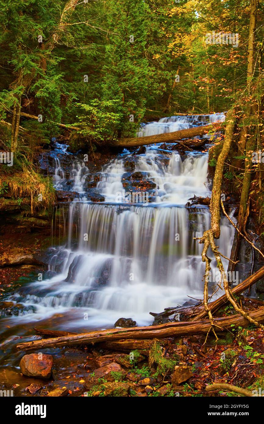 Scenic waterfalls cascading down multiple tiers in the fall forest ...