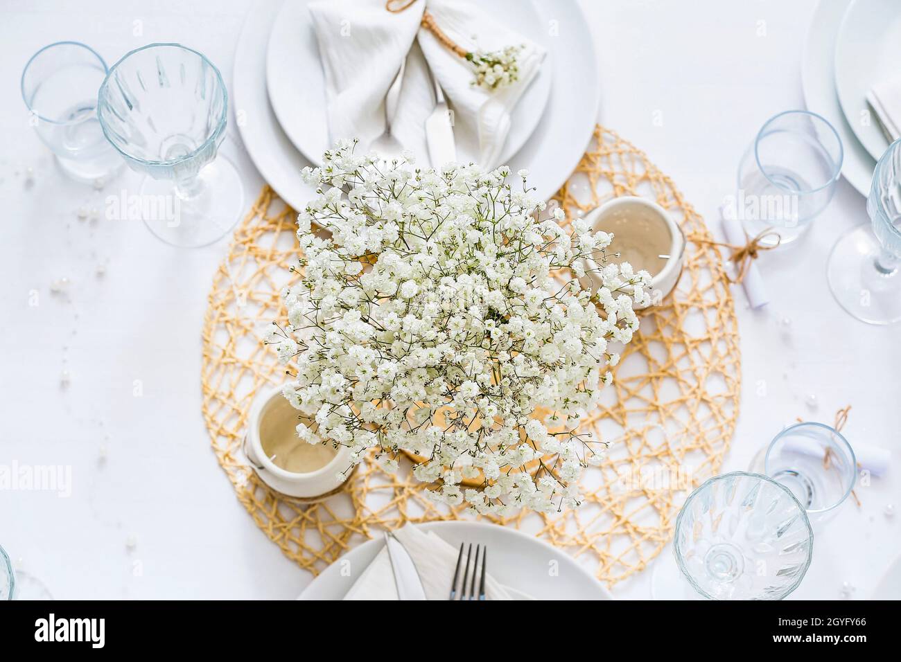 Beautiful table setting with gypsophila flowers on light background ...