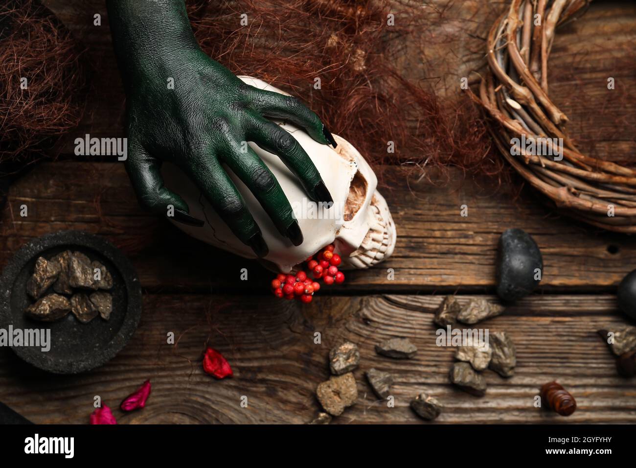 Halloween green witch's hand performing ritual Stock Photo - Alamy