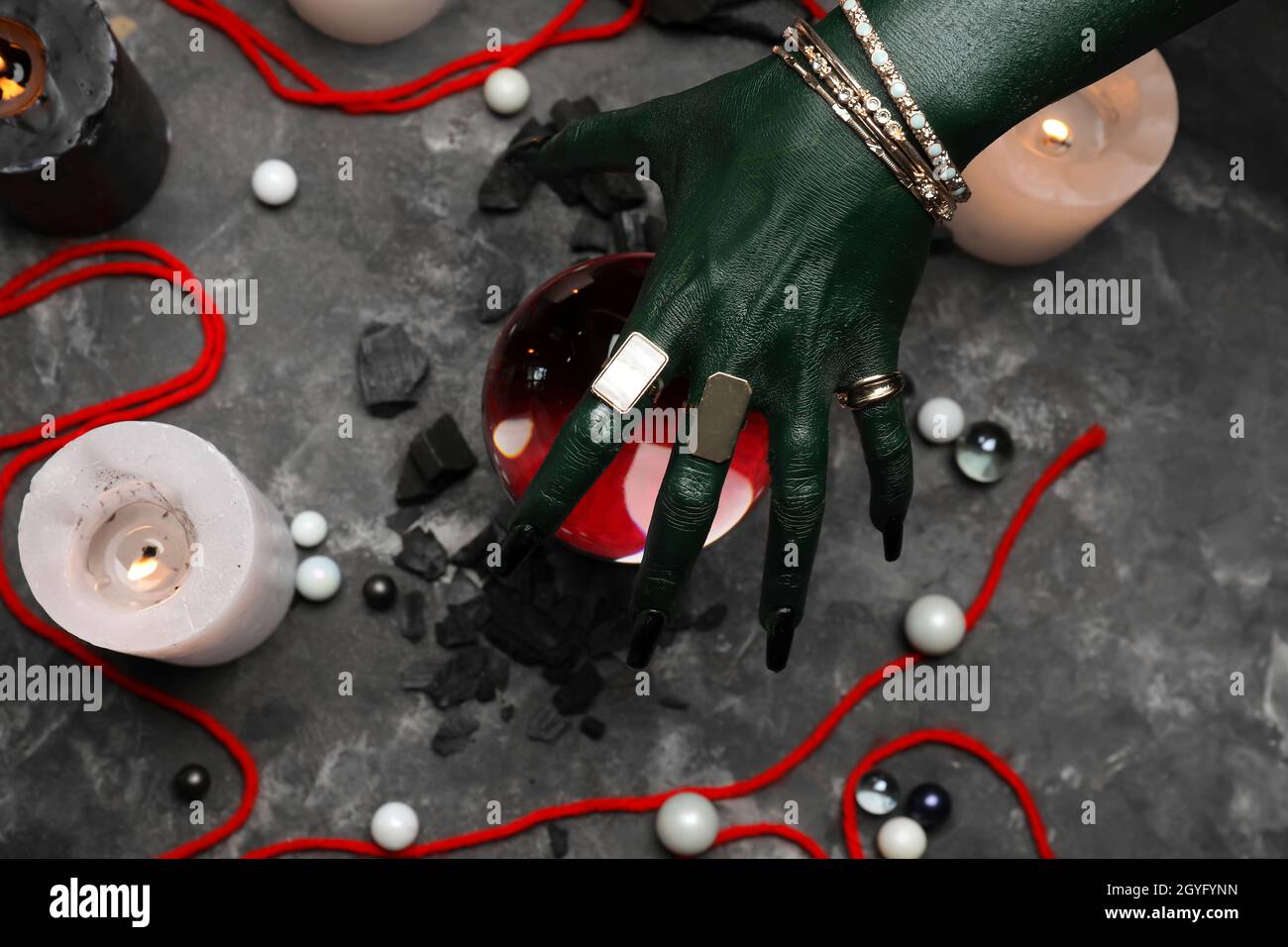 Evil witch with crystal ball at table Stock Photo - Alamy