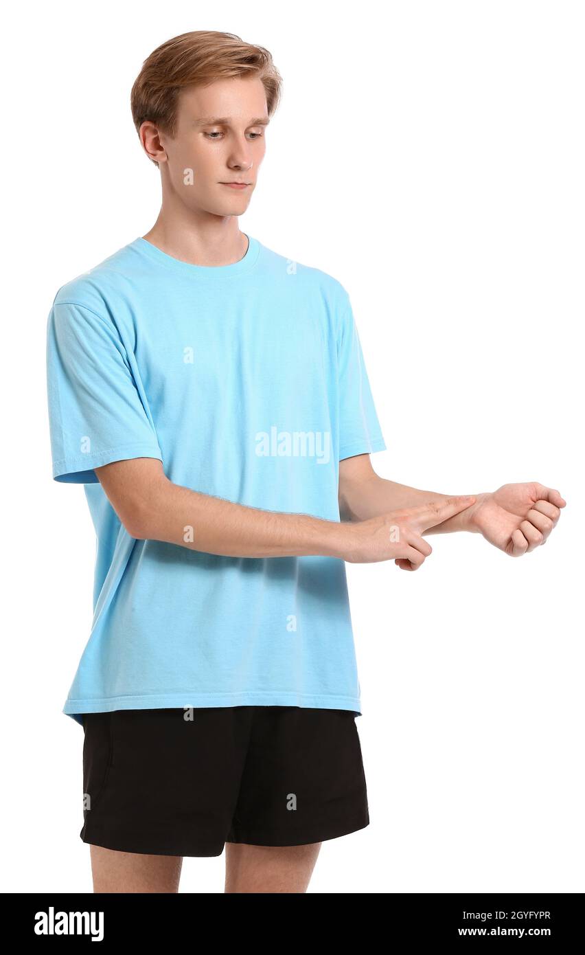 Sporty young man counting pulse on white background Stock Photo - Alamy