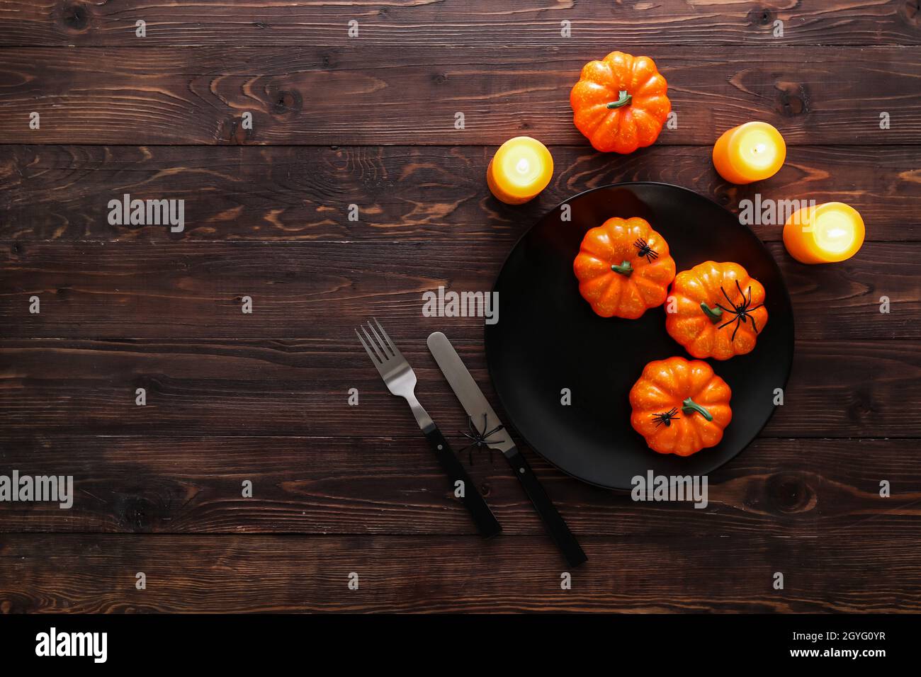 Halloween table setting with pumpkins on dark wooden background Stock ...