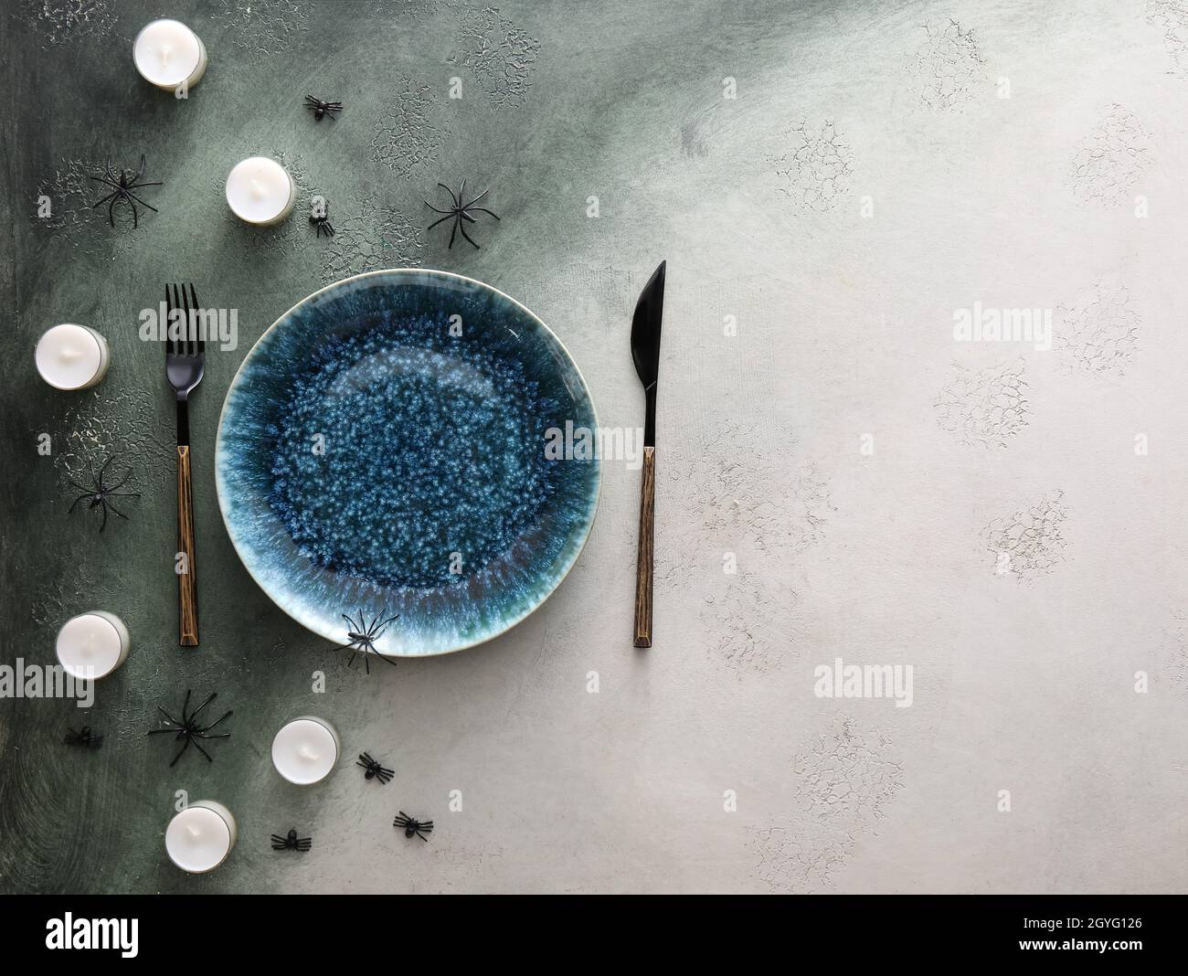 Halloween table setting with spiders on grunge background Stock Photo ...