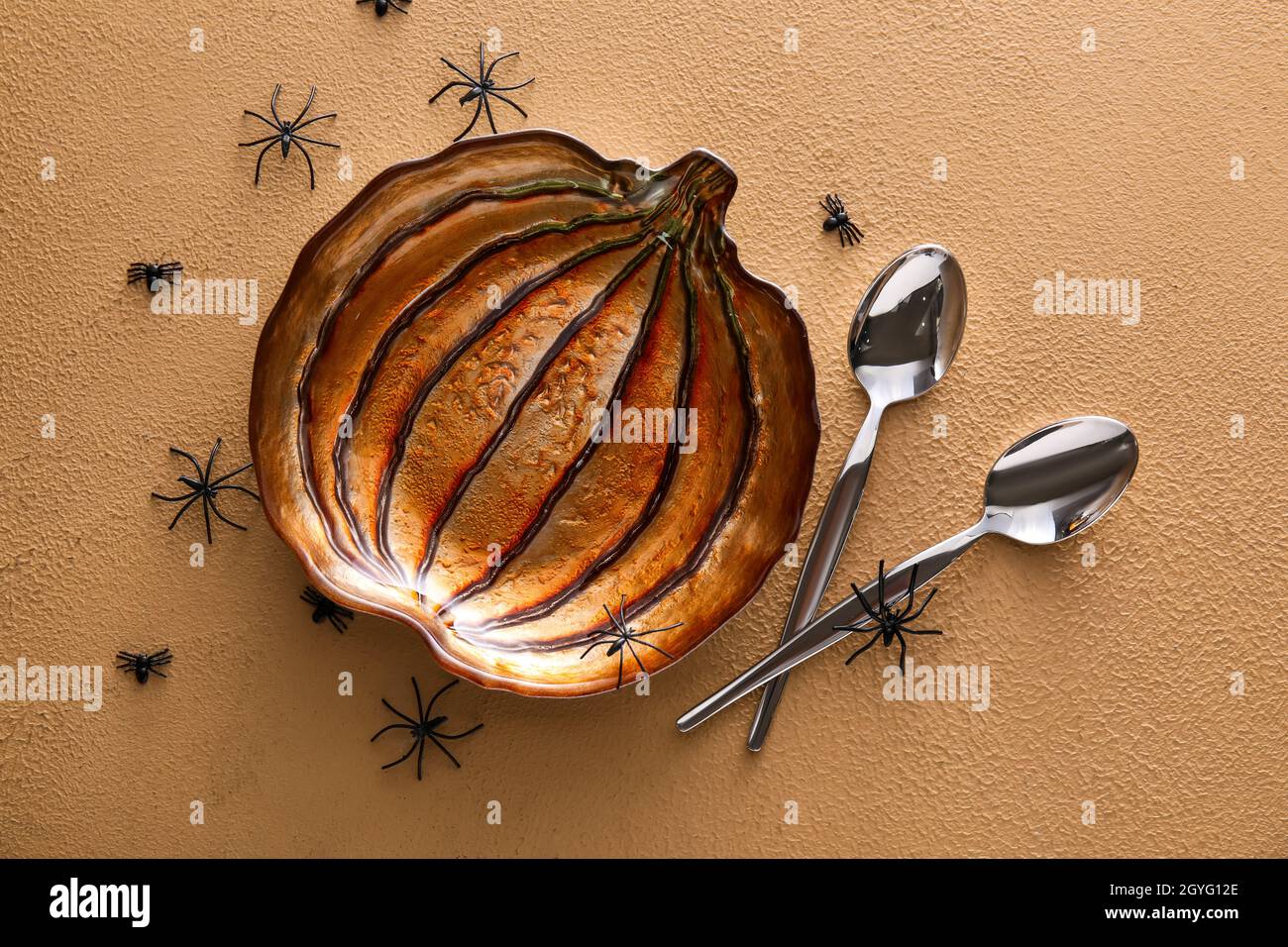 Halloween table setting with spiders on beige background Stock Photo ...