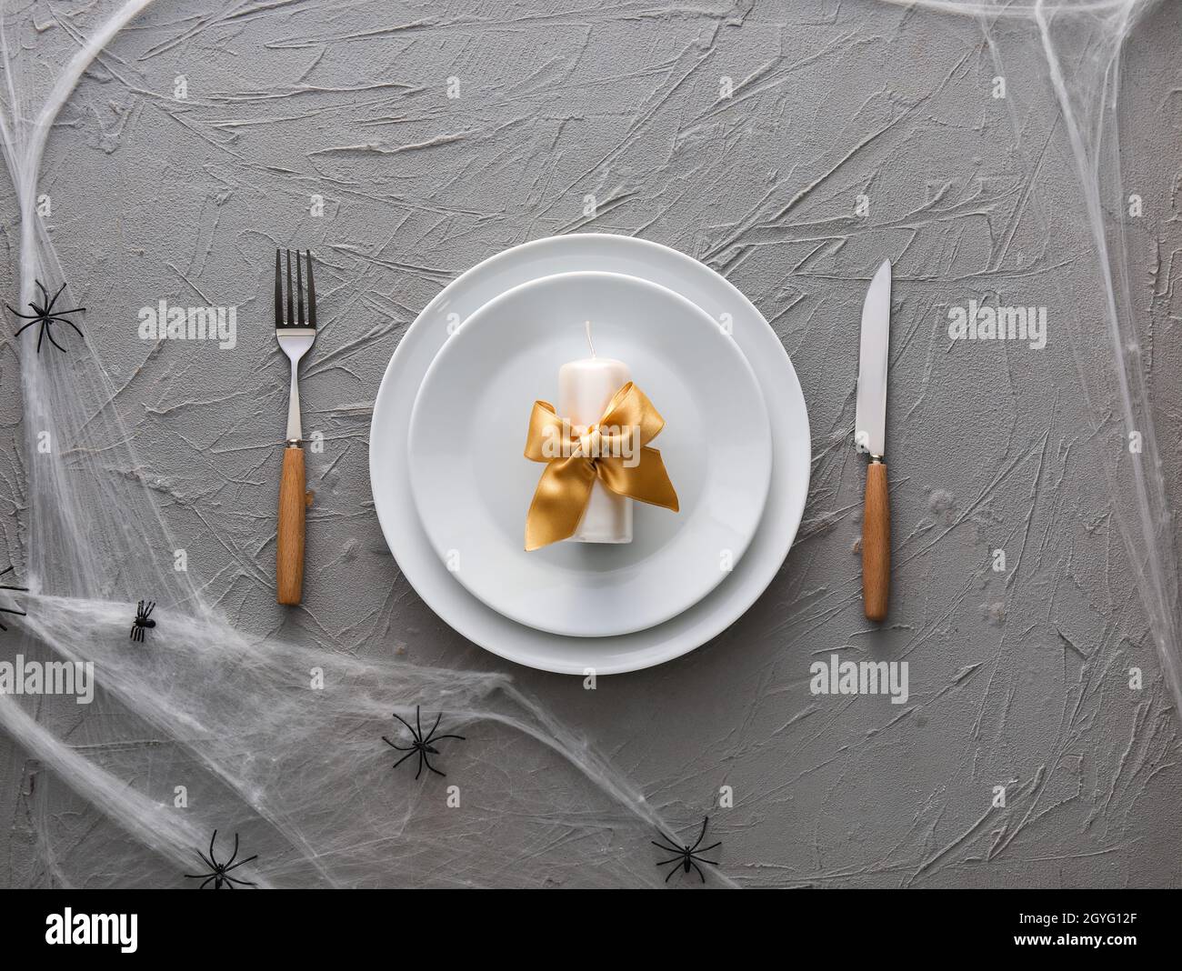 Halloween table setting with spiders on grunge background Stock Photo ...