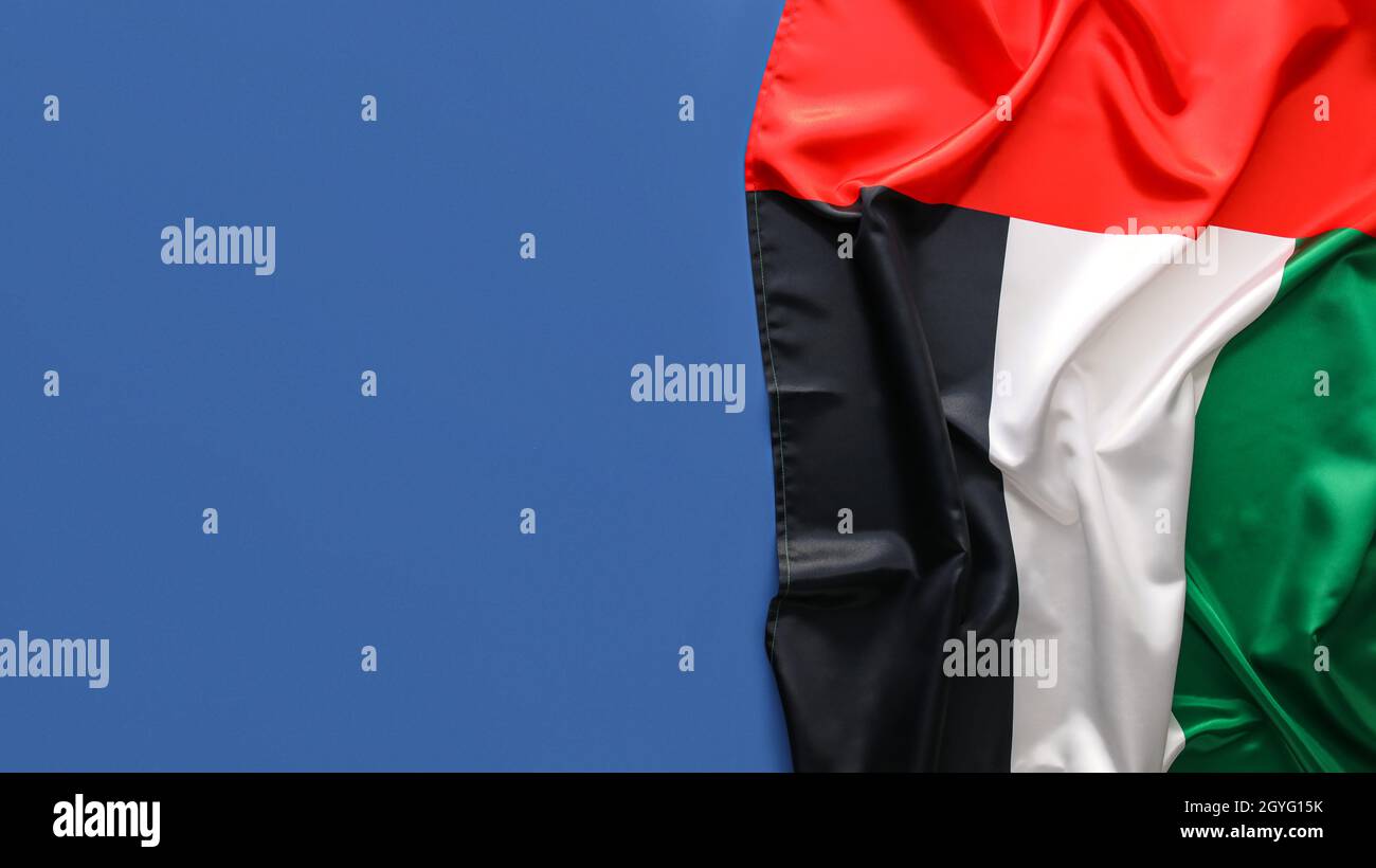 UAE national fabric flag on blue background Stock Photo - Alamy