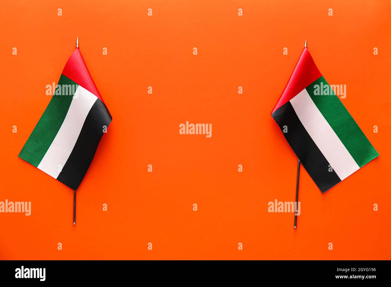 National UAE flags on red background Stock Photo - Alamy
