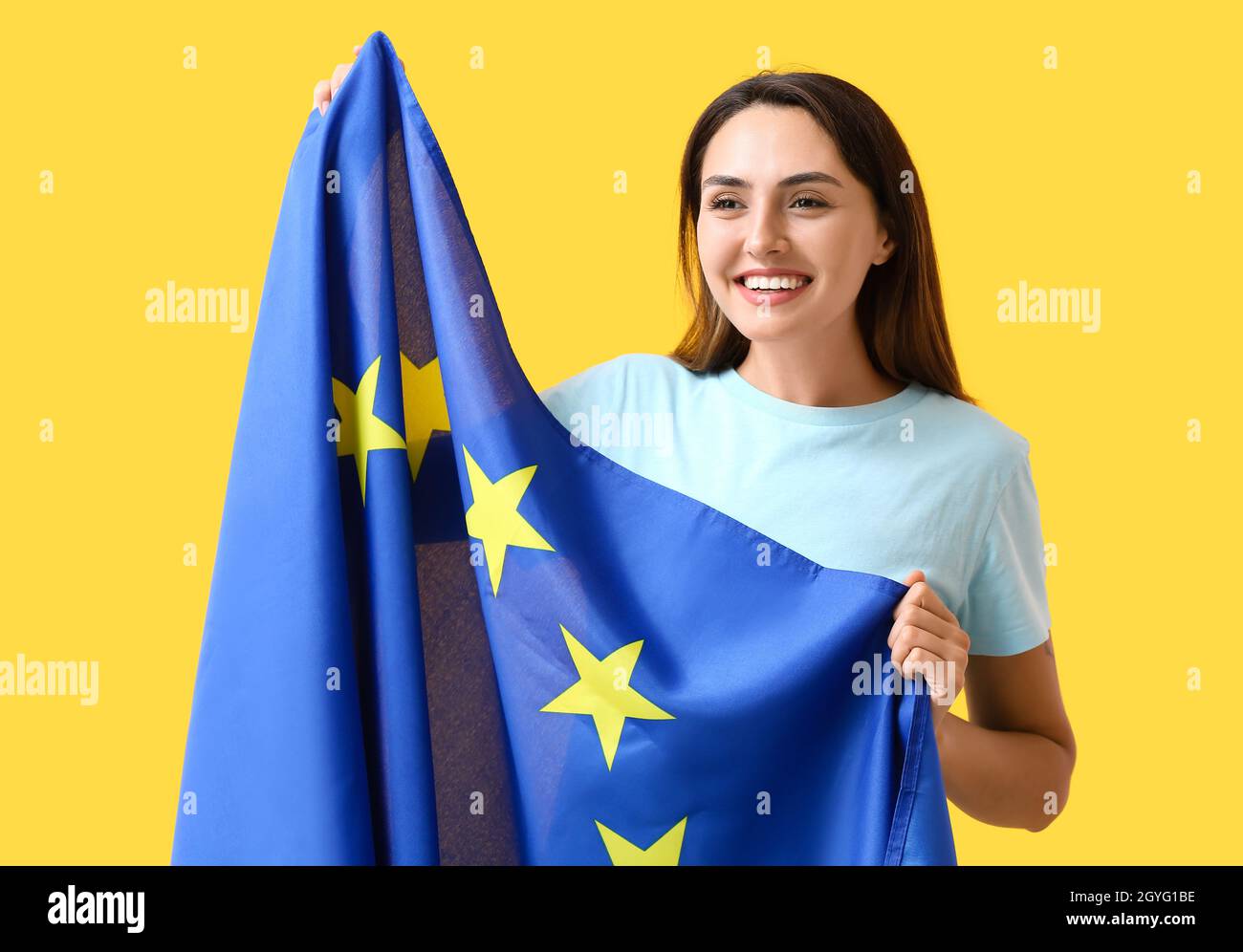 Young woman with flag of European Union on color background Stock Photo ...