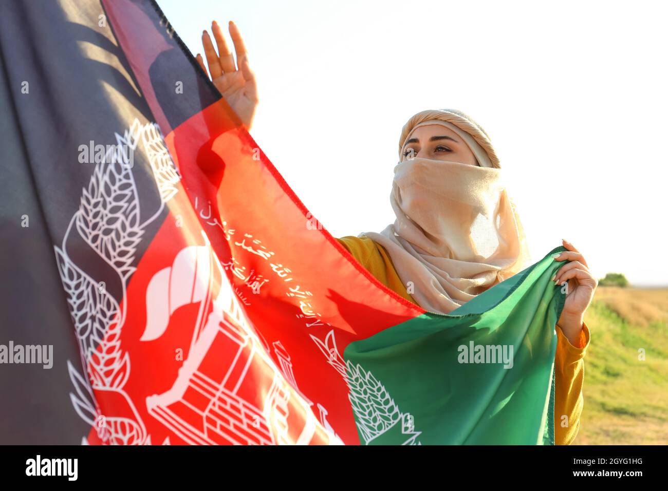 Muslim woman with flag of Afghanistan outdoors Stock Photo - Alamy