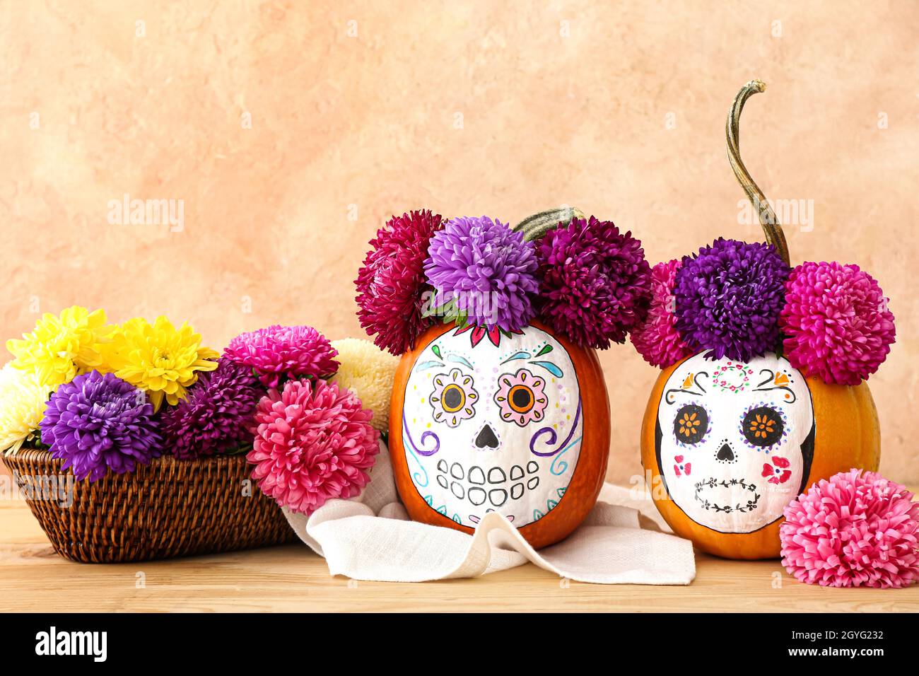 Pumpkins with painted skull on color background. Celebration of Mexico ...