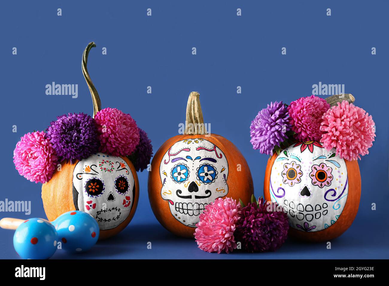Pumpkins with painted skull on color background. Celebration of Mexico ...