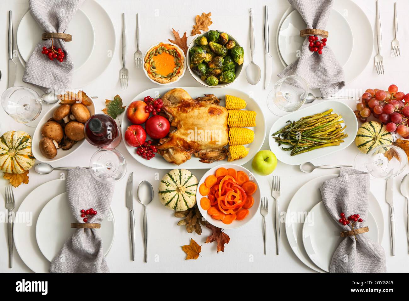 Table with roasted turkey and different food served for Thanksgiving ...