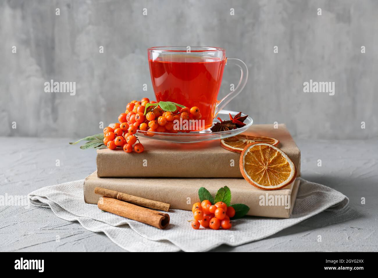 Composition with tasty rowan tea and books on grunge background Stock ...