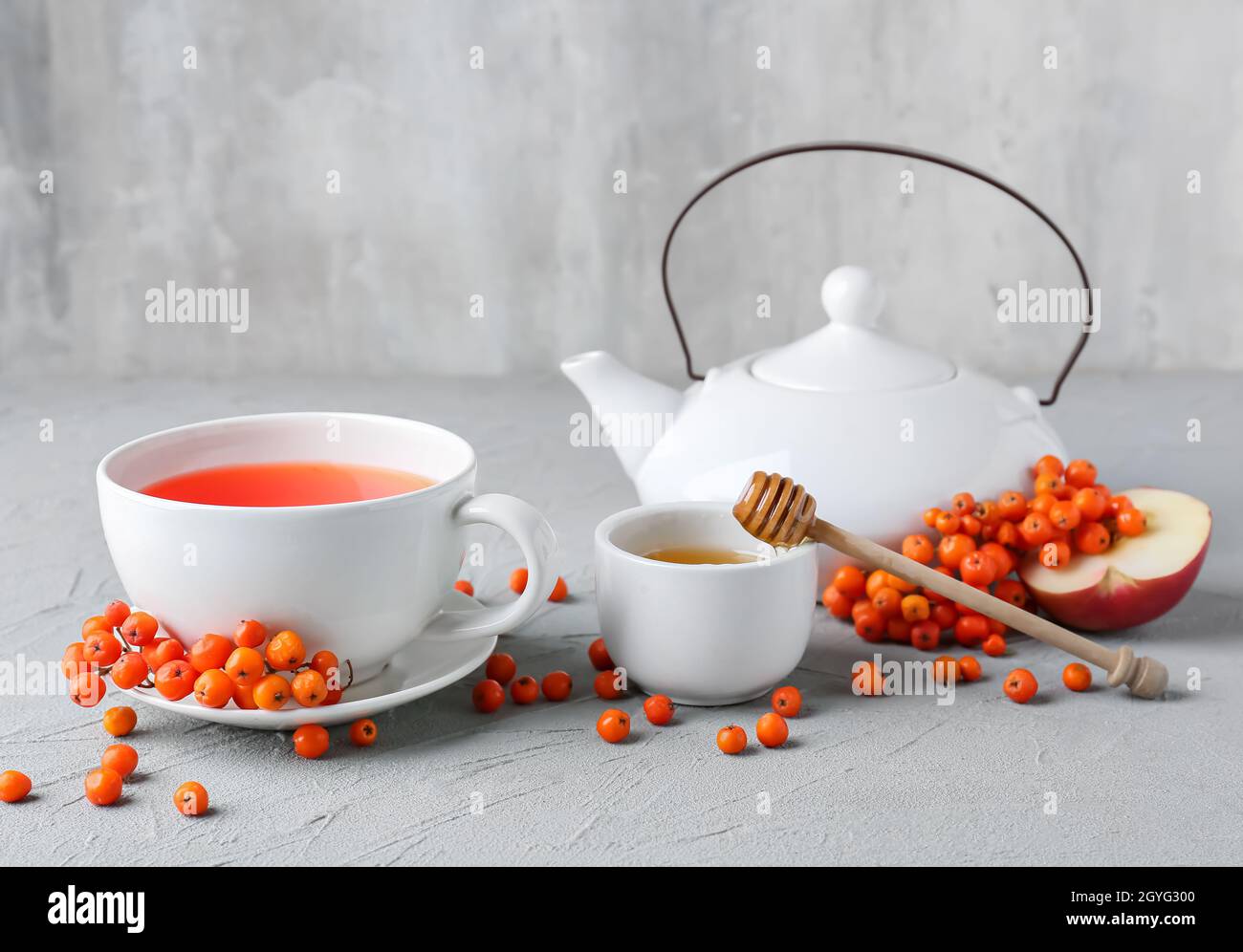 Composition with cup of tasty rowan tea, honey and berries on grunge ...