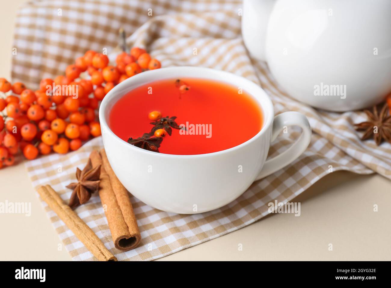 Cup of delicious rowan tea and spices on color background Stock Photo ...