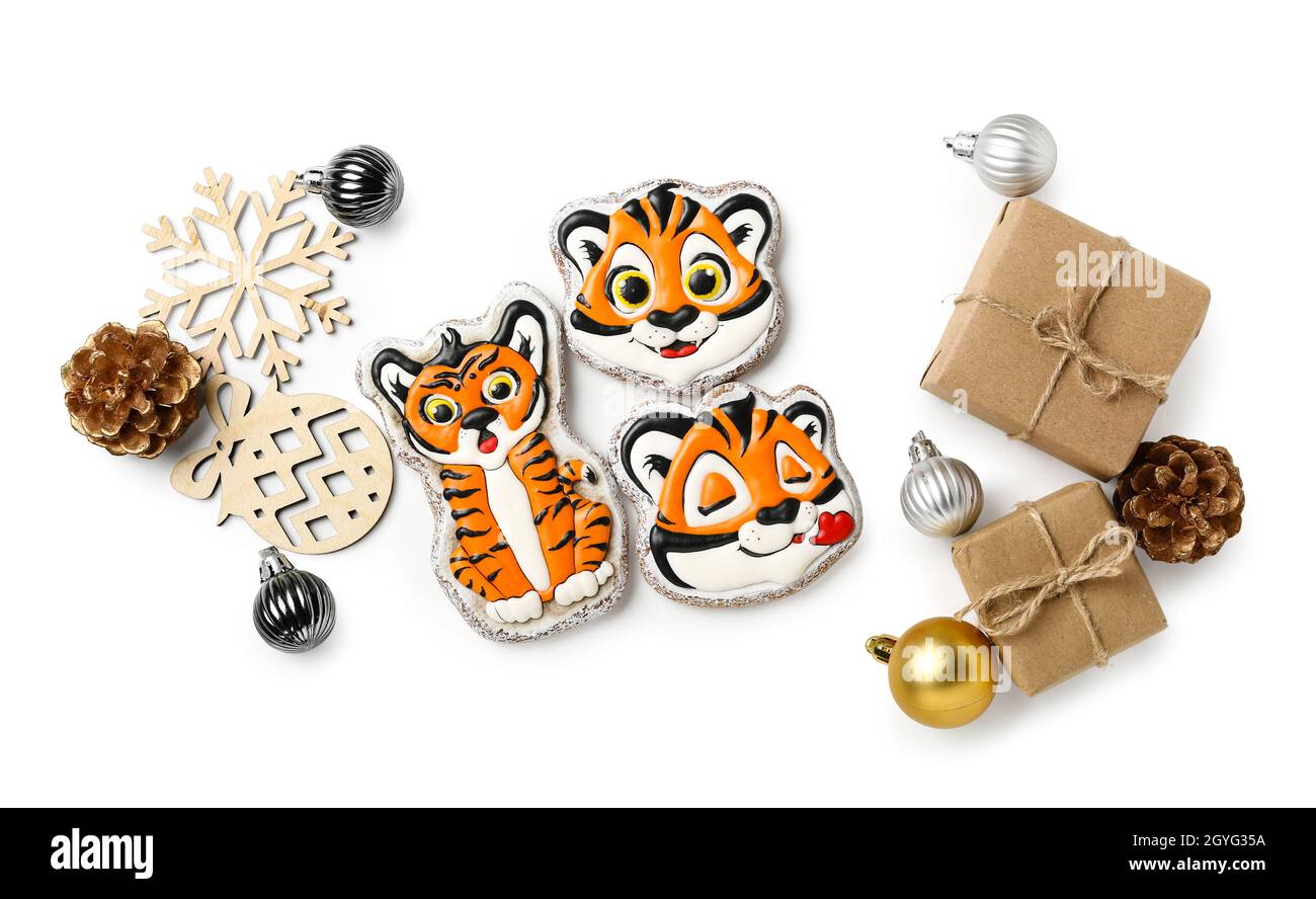 Cute cookies in shape of tiger and New Year decor on white background ...