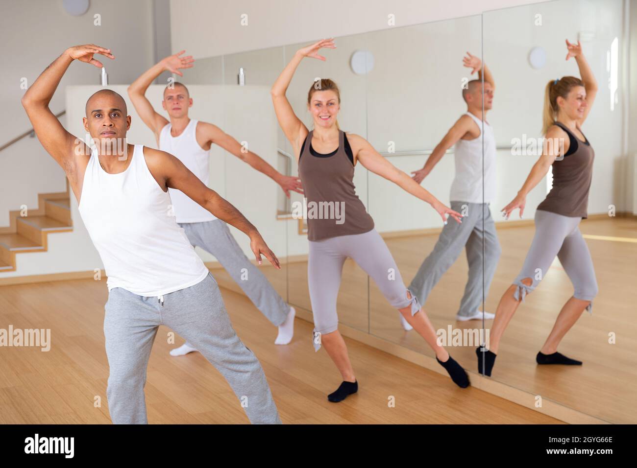 Hispanic man practicing classic dance moves during group class Stock ...
