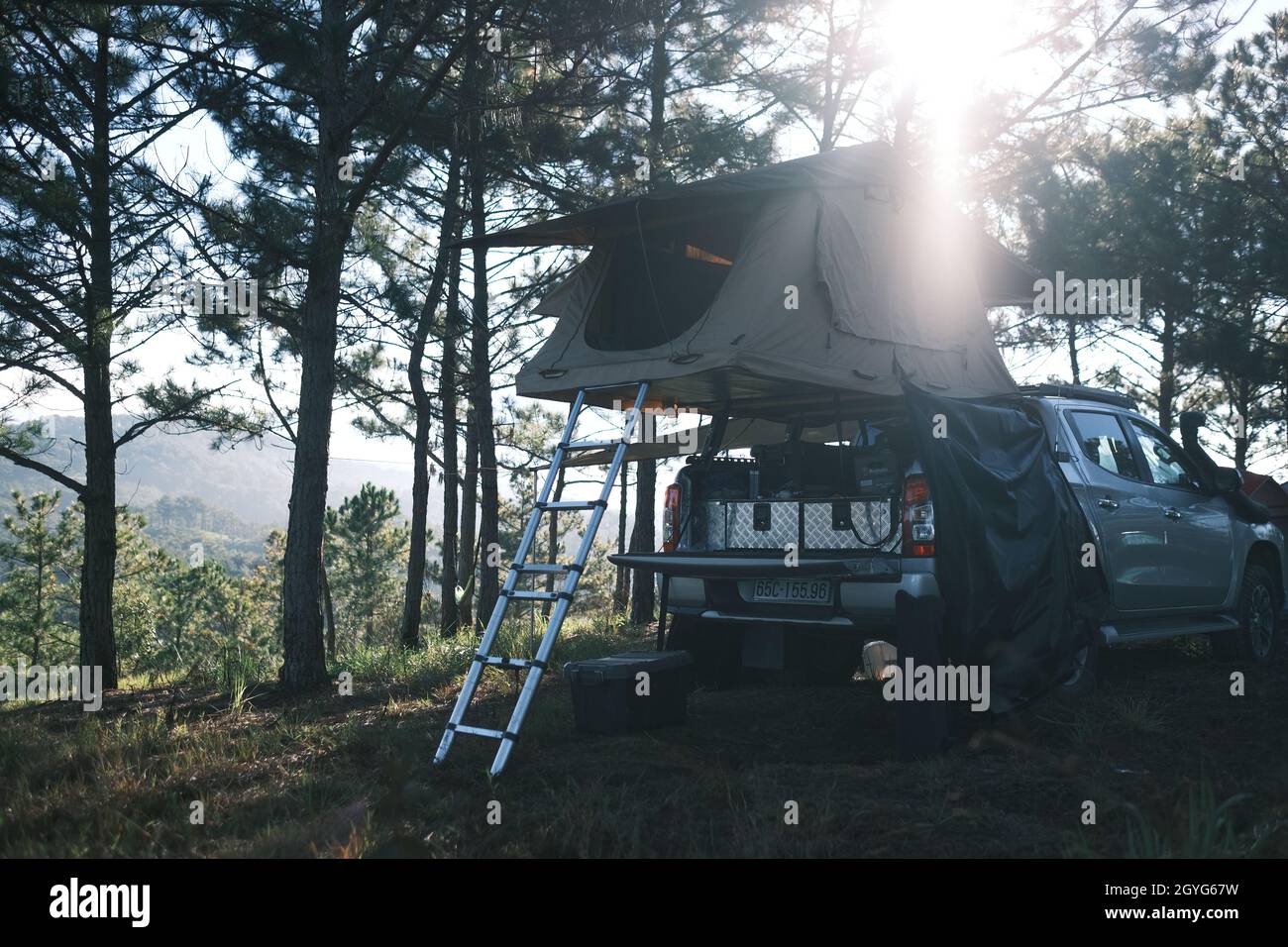 Camper enjoying the alternative vacation - car with tent on the roof ...