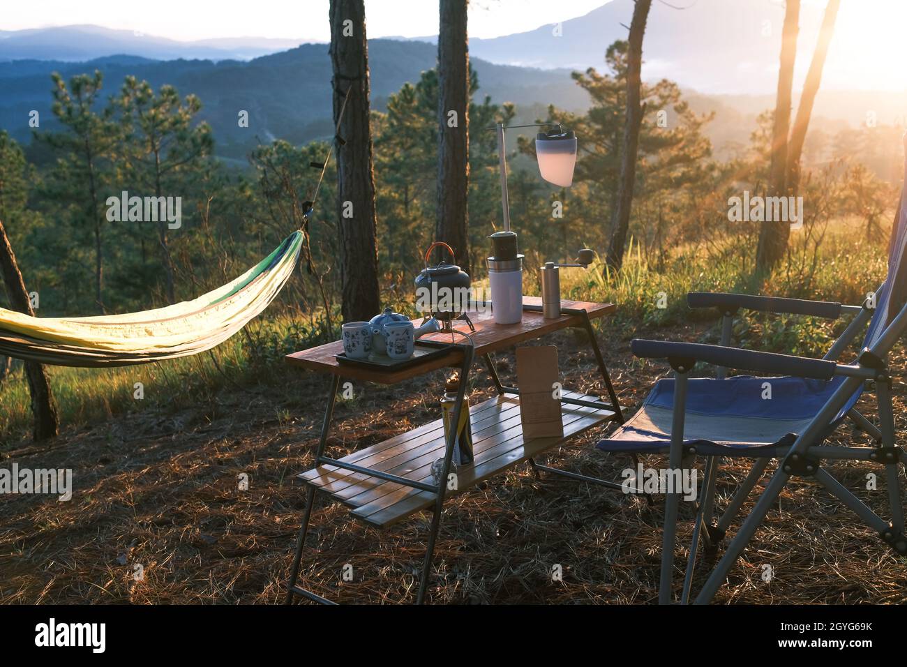 Coffee drip while camping in forest with sunshine. Coffee maker outdoor ...