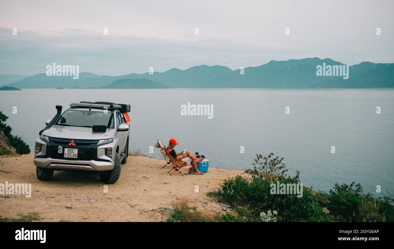 Traveling by pickup truck and camping with rooftop tent. Mitsubishi ...