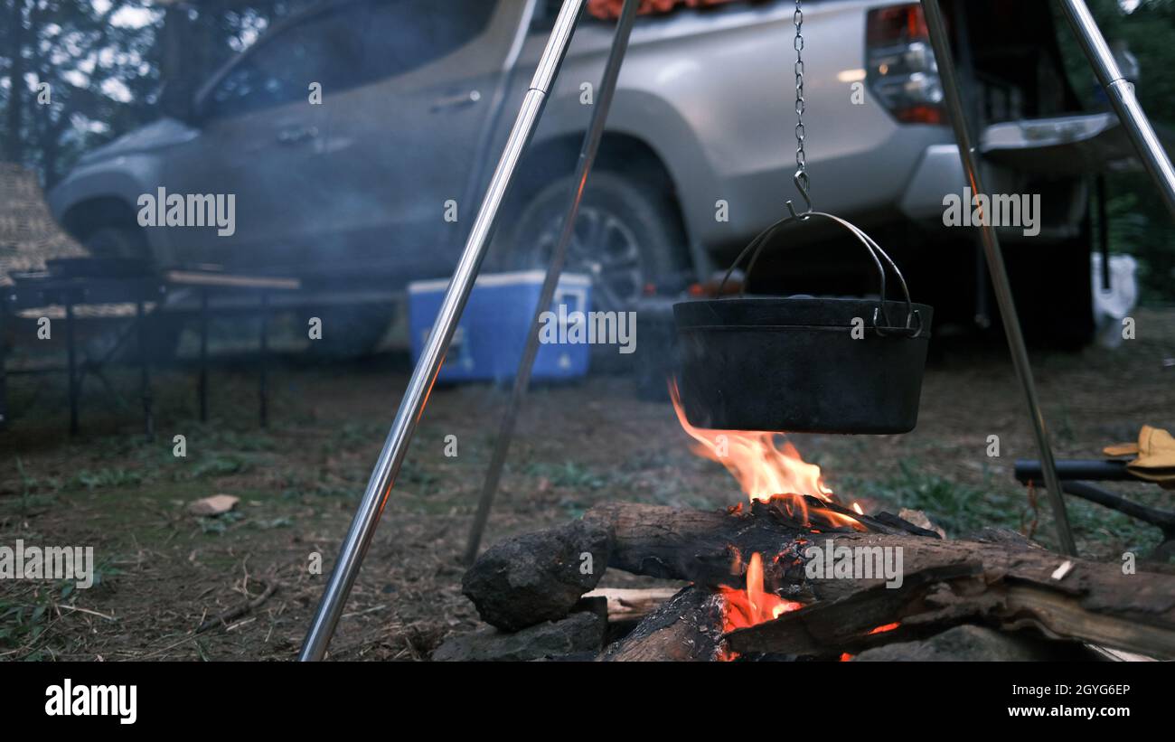 Camping outdoors in nature. Cooking pot hanging over a campfire on a ...