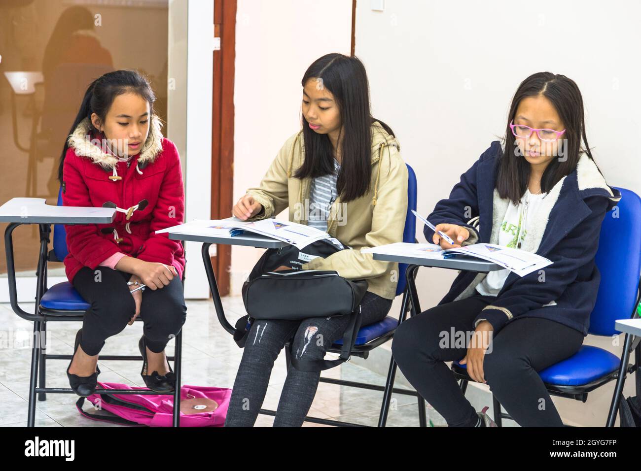 Three female students work on problems Stock Photo - Alamy