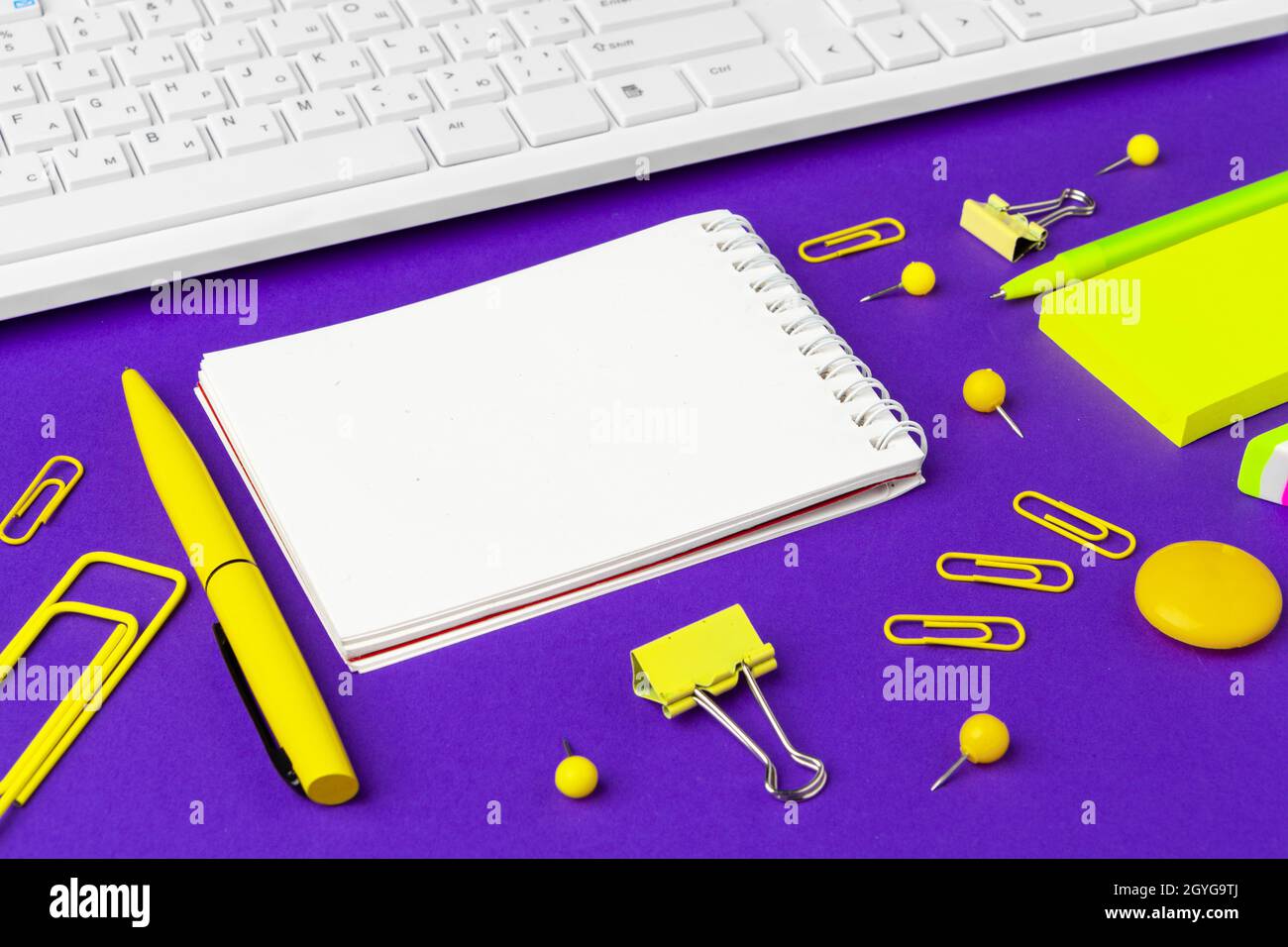 Composition of office lifestyle items on purple background, computer ...