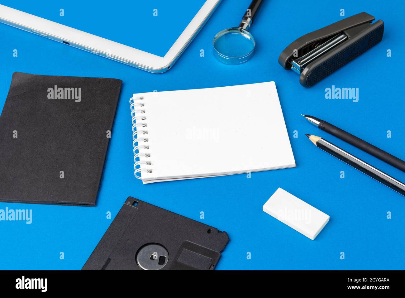 Flat lay, top view of blue office table desk. Workspace with blank note ...