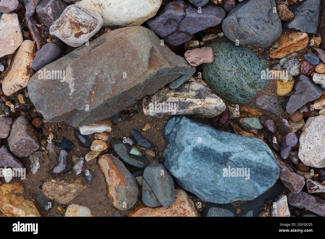 Multi-colored rocks in a meandering streambed in the Polychrome area ...