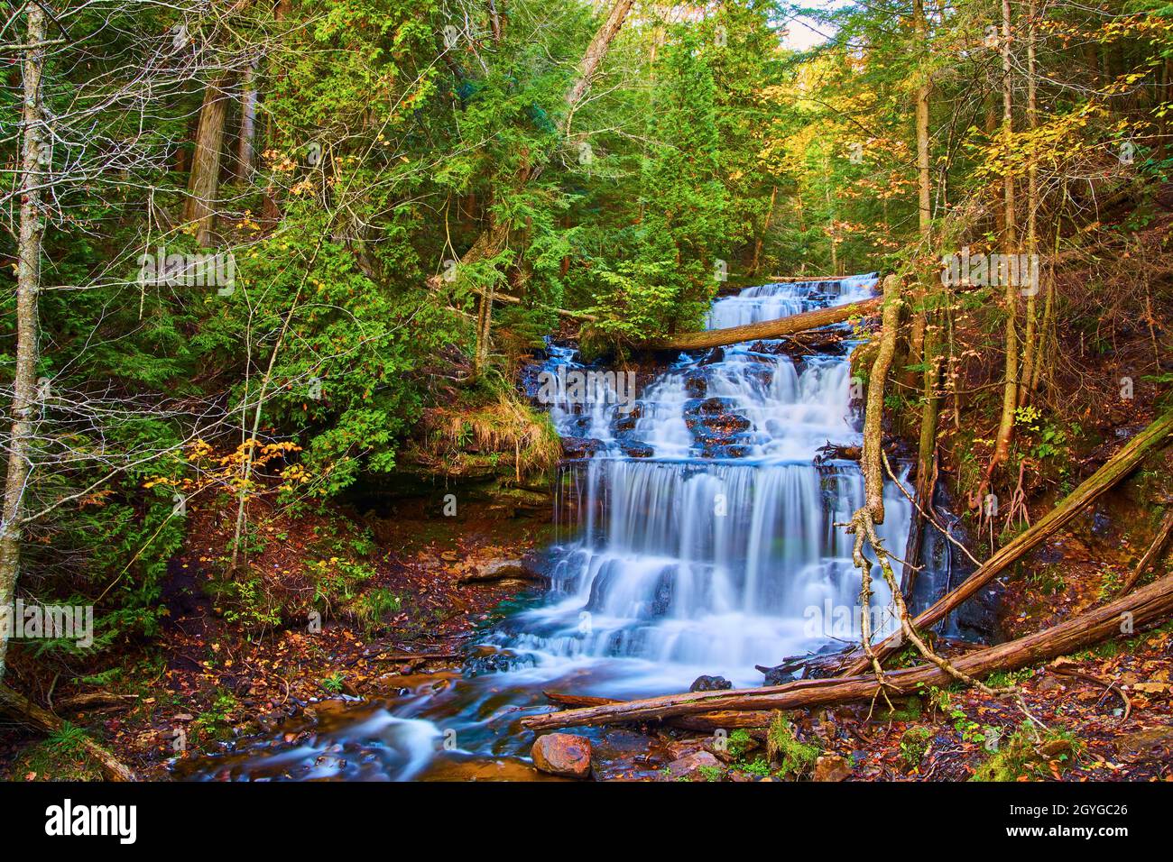 Majestic waterfalls cascading down river layers in forest near fall ...