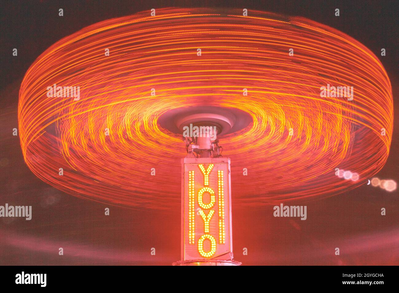 Creepy YOYO fair or carnival ride at night in infrared Stock Photo - Alamy