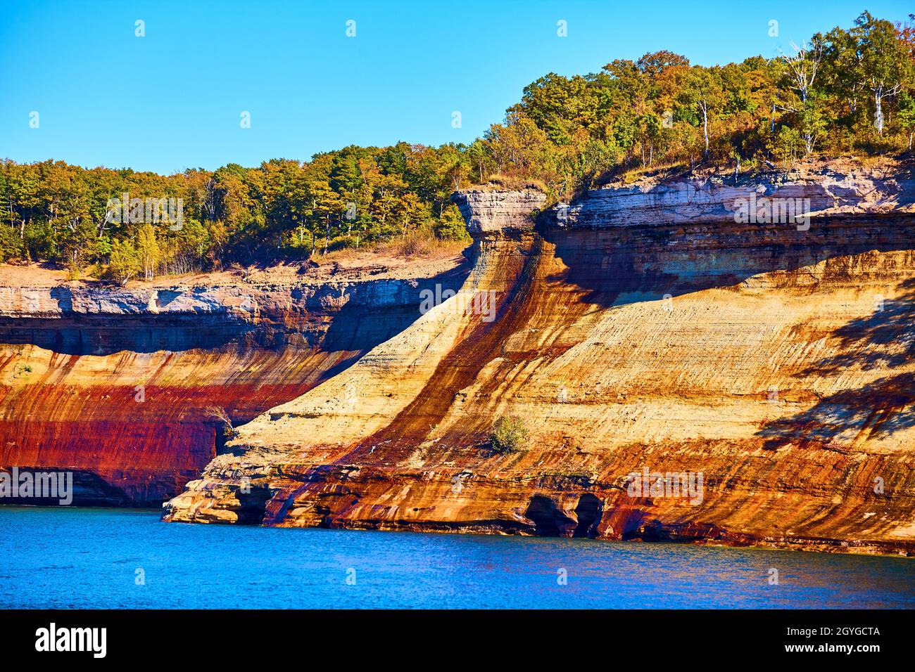 Pictured Rocks with mostly red and orange rock surface and a meager ...