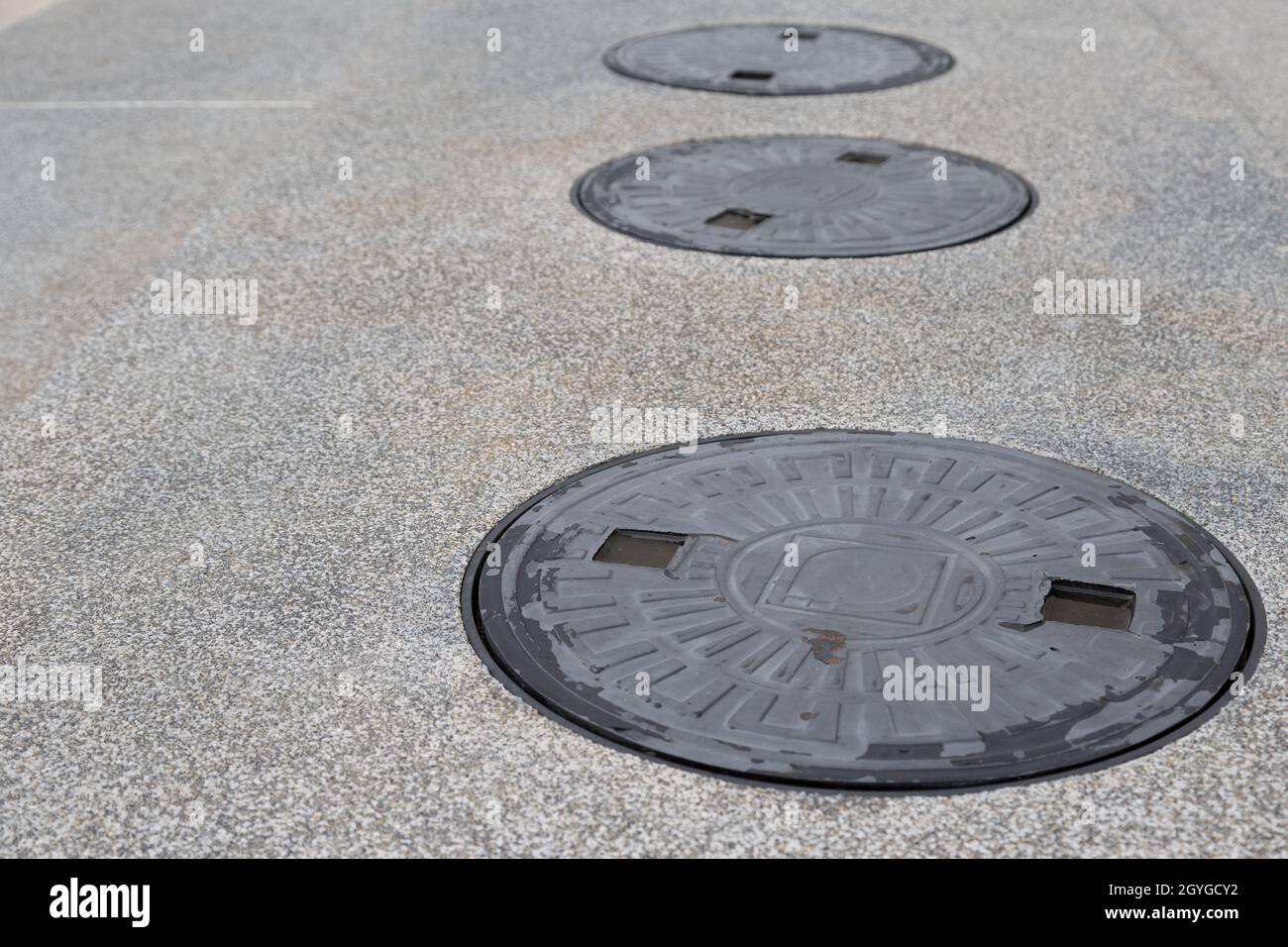 Metal drain cap cover on the walk way background Stock Photo - Alamy