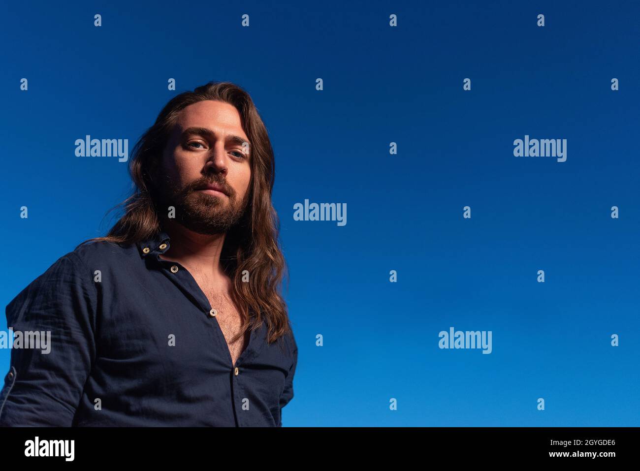 Contemporary Jesus christ facing the camera during sunset Stock Photo ...
