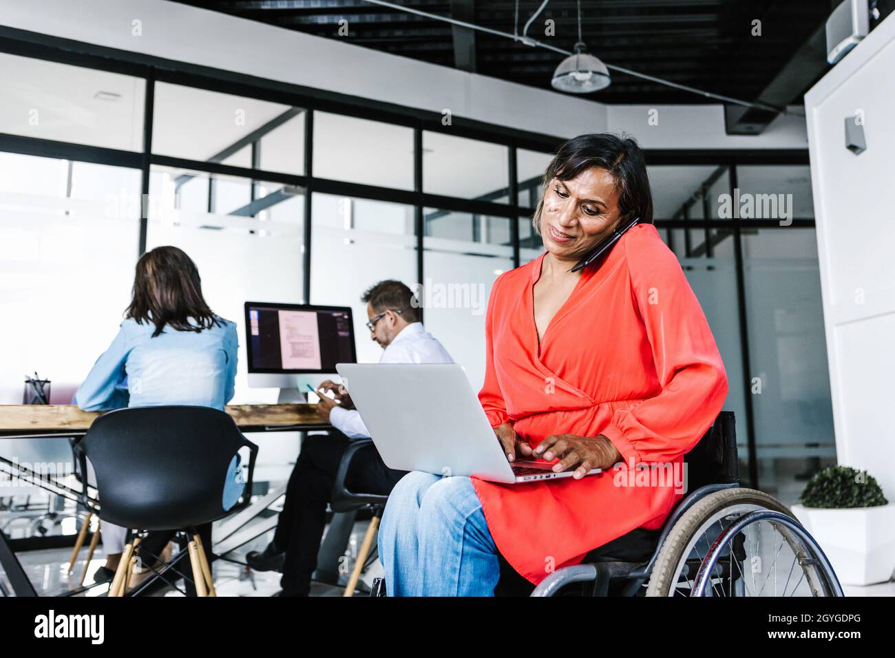 Mexican transgender businesswoman in wheelchair making phone call while ...