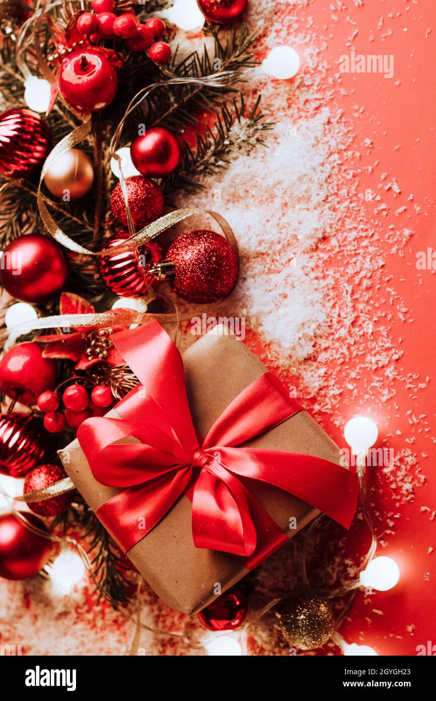 Festive boxes with a satin red bow on a red background with Christmas ...