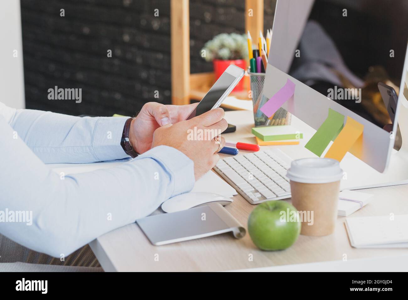 Business man hands busy using cell phone at office desk Stock Photo - Alamy