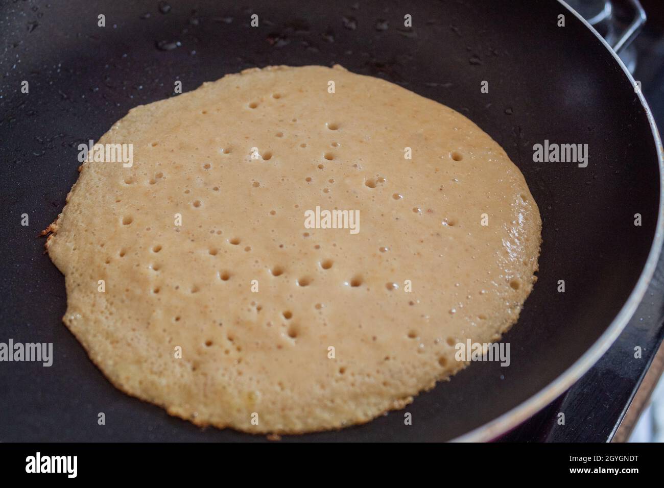 Close-up of raw pancake on a frying pan Stock Photo - Alamy