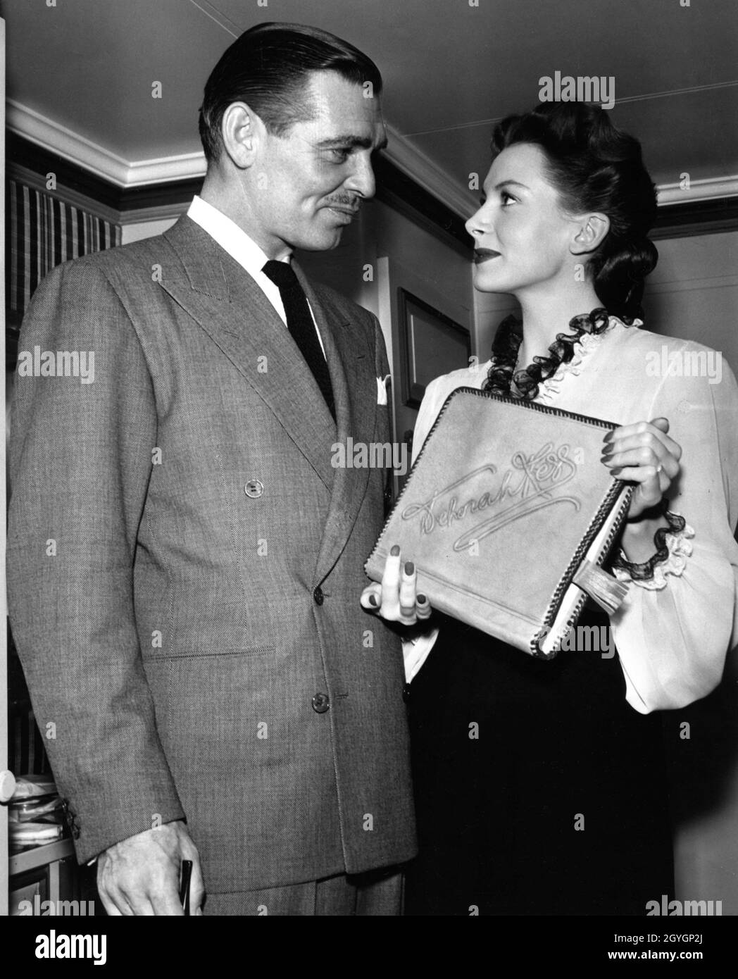 CLARK GABLE presents his leading lady DEBORAH KERR with a Leather ...