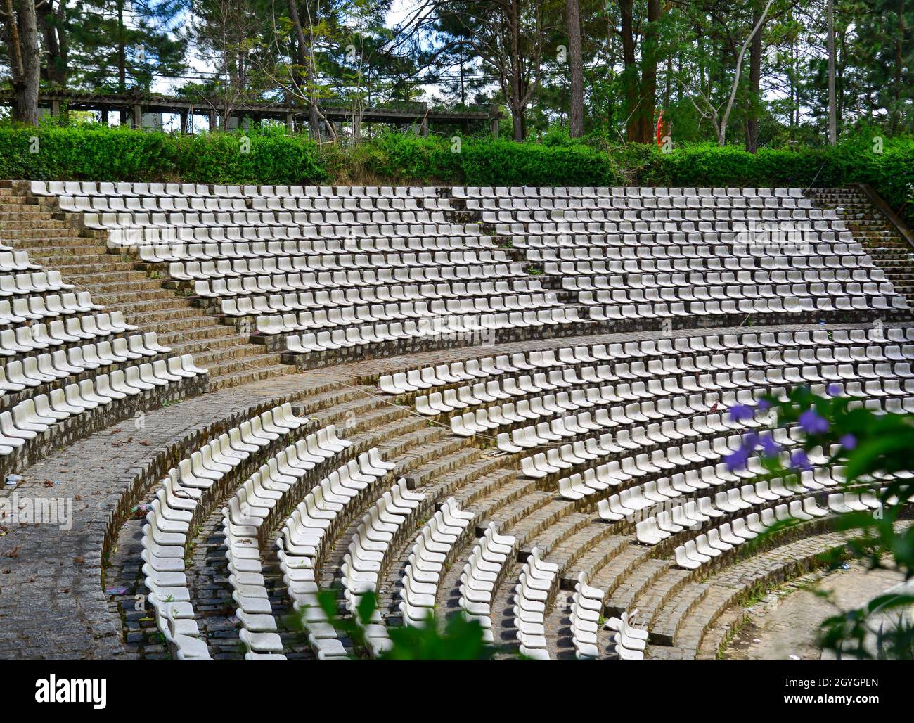 The rows of seats of an abandoned outdoor stage are slowly being ...