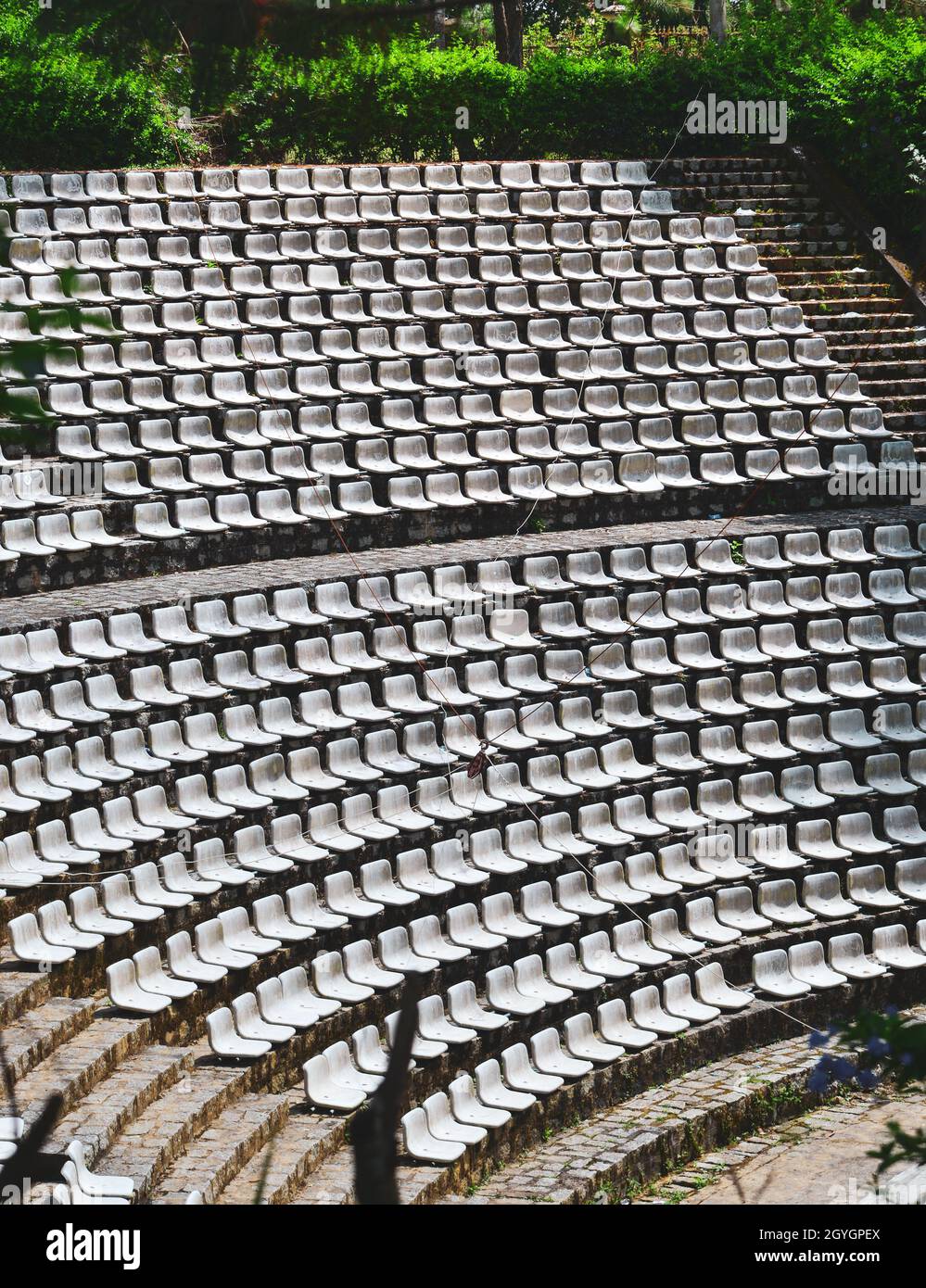The rows of seats of an abandoned outdoor stage are slowly being ...