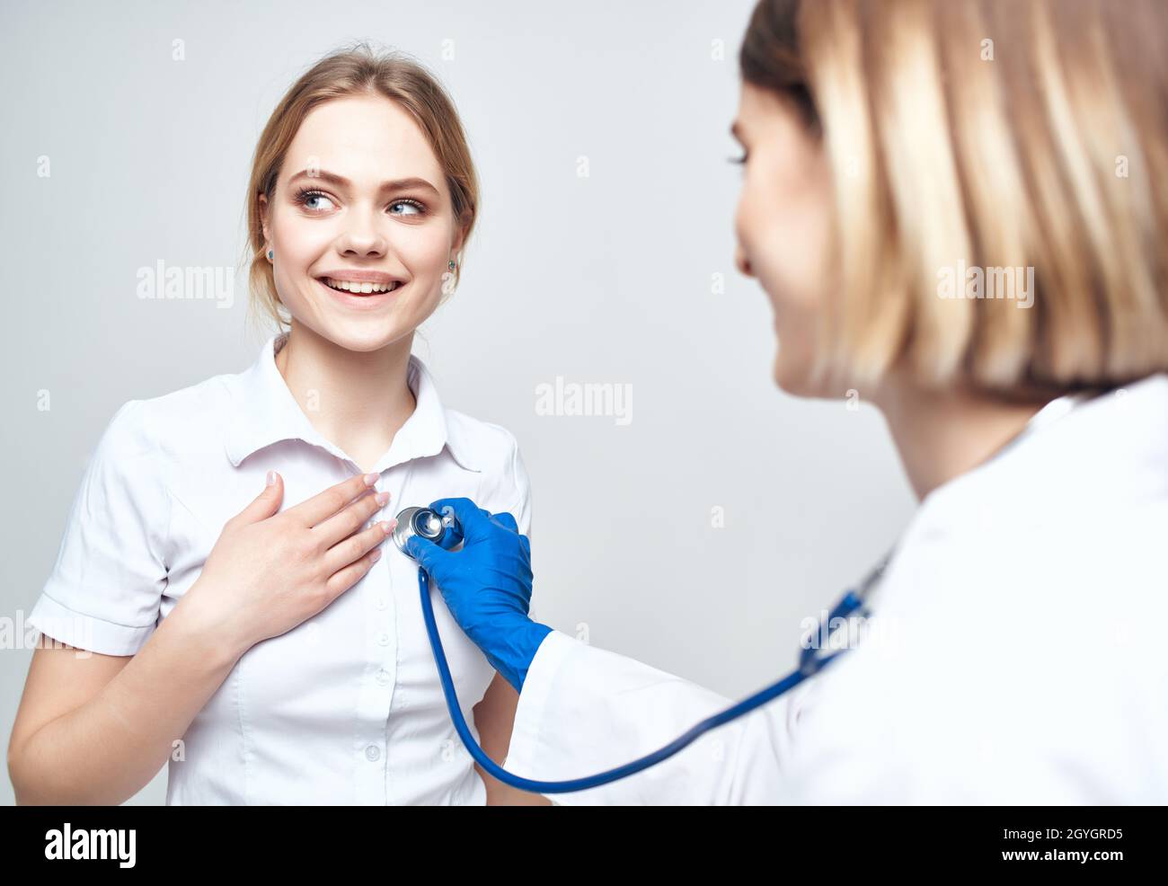 nurse stethoscope healing procedures light background Stock Photo - Alamy