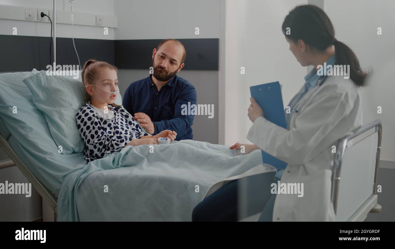 Physician doctor discussing illness treatment with sick kid patient and ...