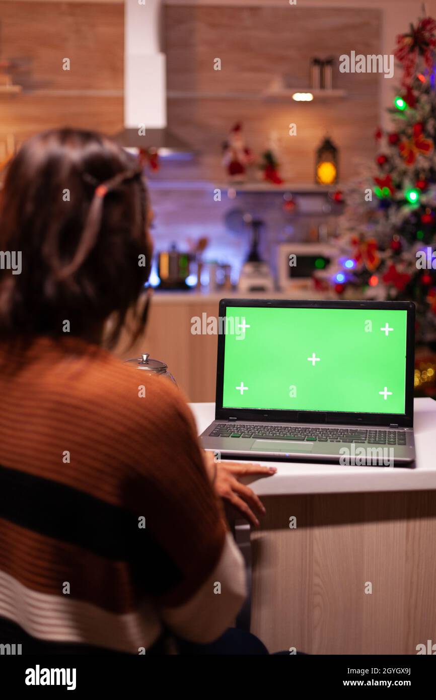 Caucasian adult looking at laptop computer with green screen modern ...