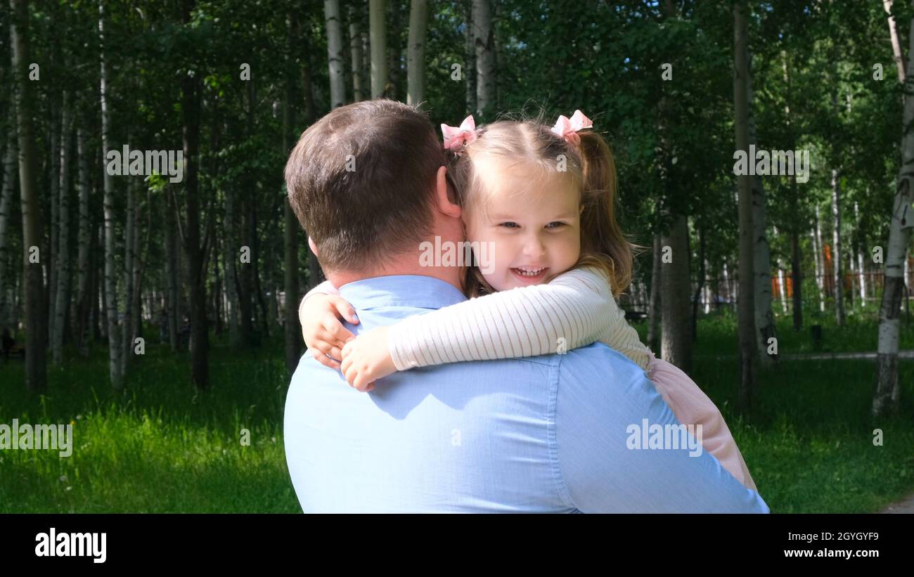 Happy father carrying around his neck and hugging daughter 4-5 years ...