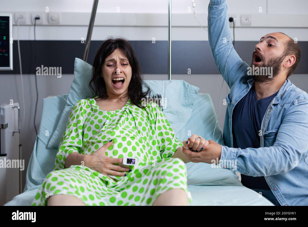 Woman with pregnancy having painful contractions getting into labor and ...