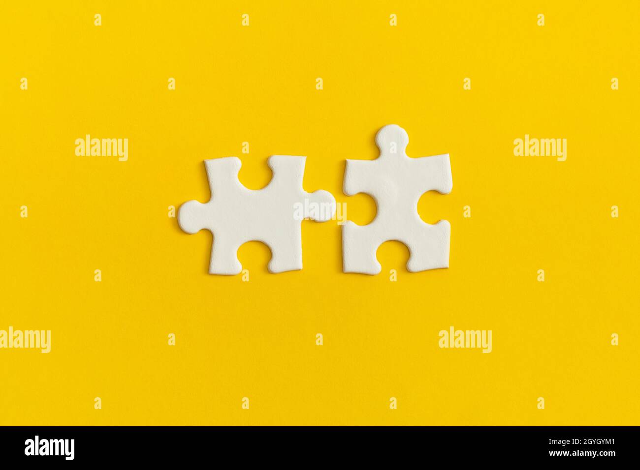 White details of puzzle on yellow background Stock Photo - Alamy