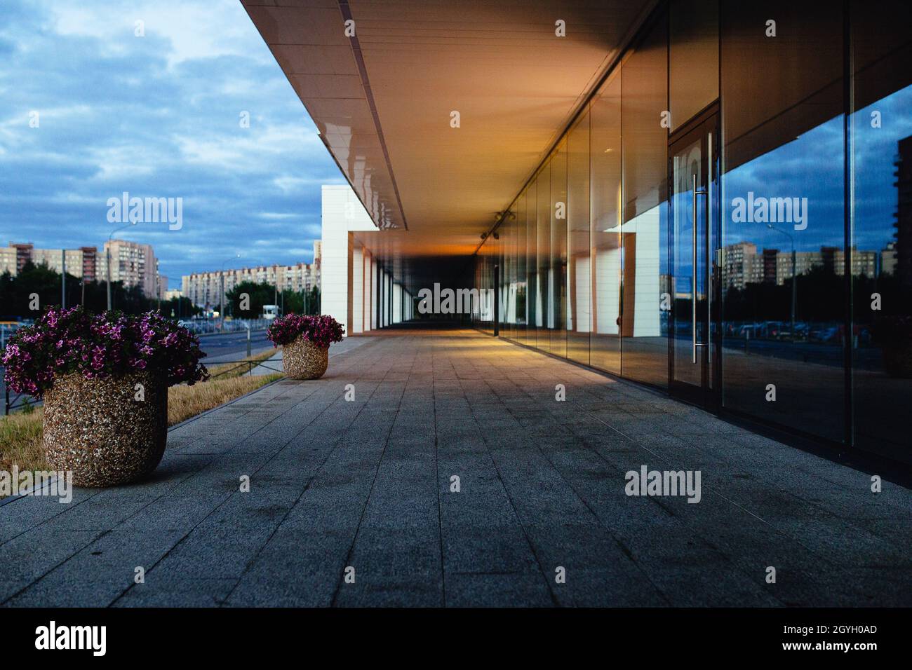 Empty building patio in front of the glass windows Stock Photo - Alamy