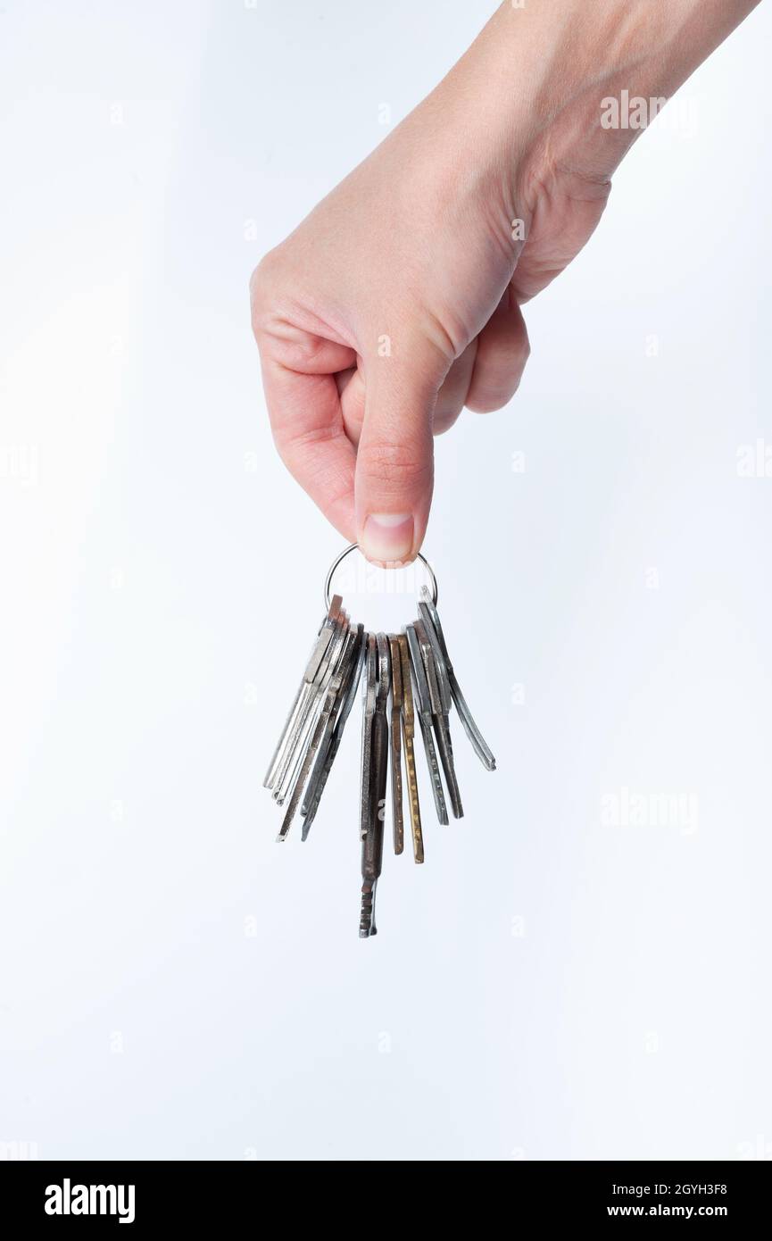 hand holds a bunch of keys from the apartment isolated on white ...
